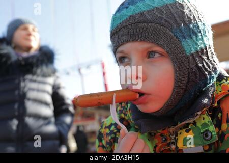Kid eating sausage on street in Moscow, Russia Stock Photo - Alamy