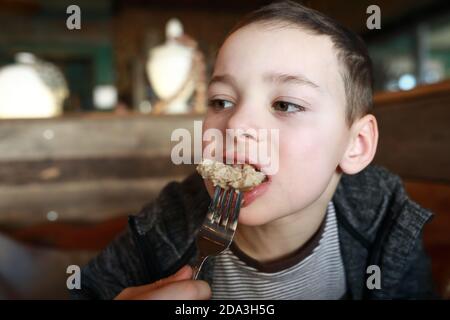 Boy eats chicken Stock Photo - Alamy