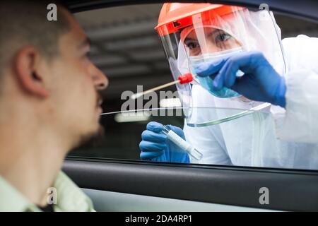 Medical worker taking sample for PCR test from soldier Stock Photo - Alamy