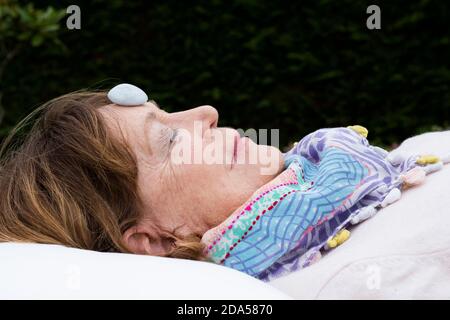 Woman with rock on forehead Stock Photo - Alamy