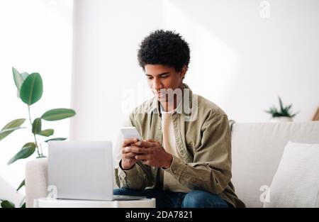 Focused teenage student using laptop for remote learning at home Stock ...