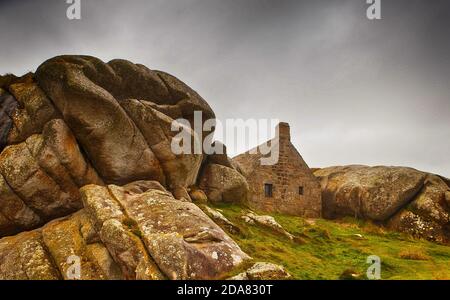 rustic house built between two large stones, france-europe Stock Photo ...