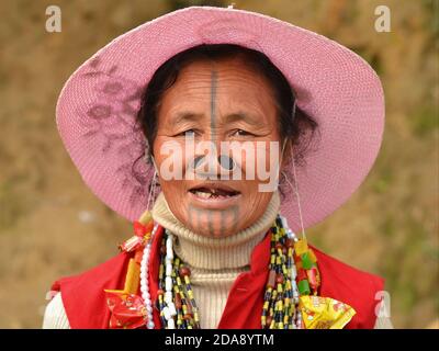 Apatani tribal woman with traditional yaping hullo (nose plugs) and ...
