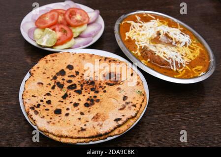 Indian flatbread tandoori roti and Malai kofta curry made in tandoor ...
