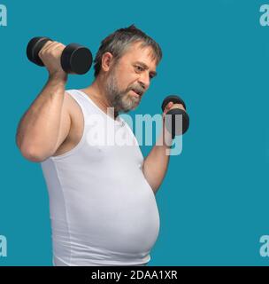 Fat man do hard exercises with a dumbbell in the gym Stock Photo - Alamy