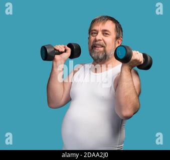 Middle-aged man with a paunch exercising with dumbbells isolated on ...