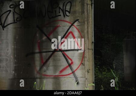 crossed out swastika on a wall, anti nazi symbol against fascism and ...