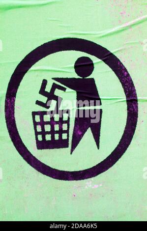 Swastika thrown in trash, symbol against fascism Stock Photo - Alamy