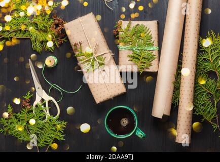 Beautiful Christmas gifts and thuja branches on green background ...