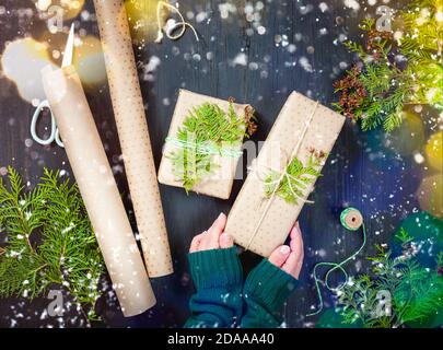 Beautiful Christmas gifts and thuja branches on green background ...