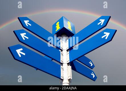 Blank directional road signs over rainbow Stock Photo - Alamy