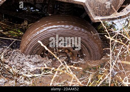 Car stuck in the mud, car wheel in dirty puddle, rough terrain Stock ...