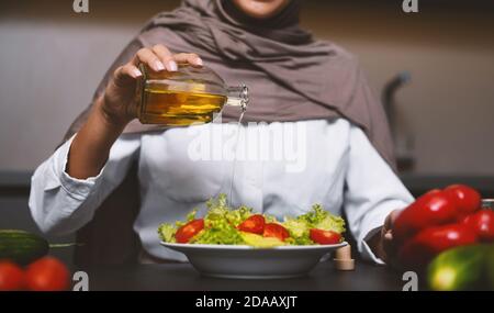Muslim Lady Cooking Drizzling Olive Oil On Vegetable Salad Preparing ...