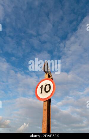 10mph, 10kph sign against a blue sky background Stock Photo - Alamy