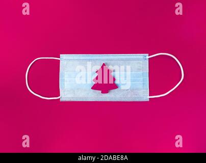 blue medical mask with christmas tree-shaped clothespins. new years ...