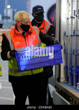 Prime Minister Boris Johnson loads baggages on a conveyor belt for an ...