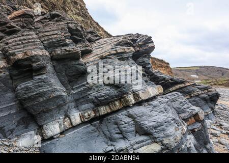 Alternating bands of sandstones and shales form the steep sides and ...