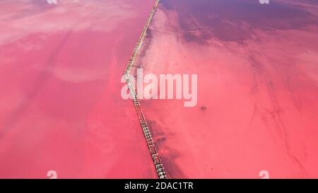 Aerial view of wooden structures for collecting salt on a pink lake ...