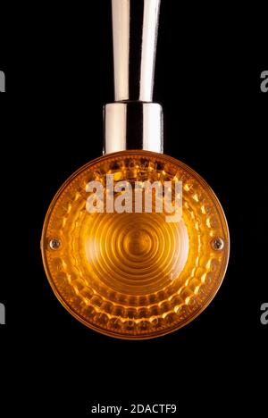 Orange turn signal light bulb in auto mechanic hand with a car blurred ...