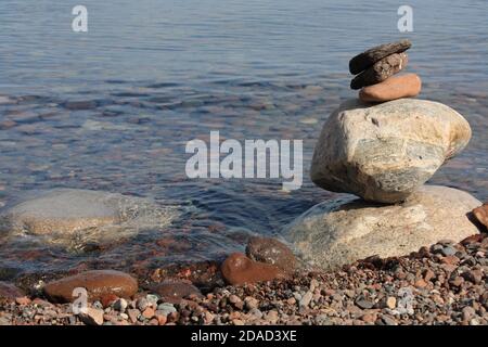 Calming stacked rocks on a big rock with yellow algae at Cathedral ...