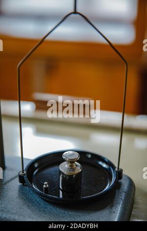 Closeup shot of an old laboratory scale for experiments with a metal ...