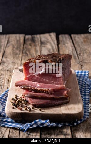 Traditional smoked meat on wooden table. Organic products on a wooden ...