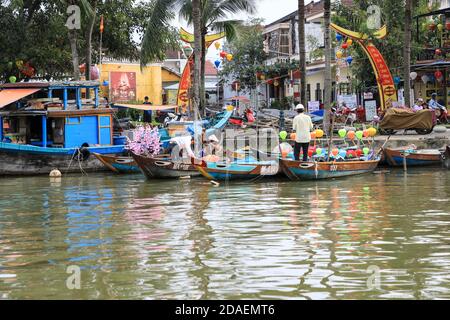 Tourist boats on Thu Bon River and historic buildings, Hoi An (UNESCO ...