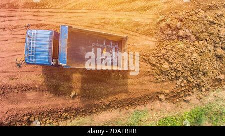 Dump truck unloads soil on the construction site. Aerial view Stock ...