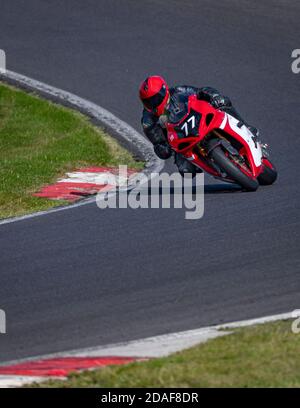 A shot of a racing bike cornering on a track Stock Photo - Alamy