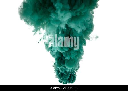 Green smoke bomb exploding against white background Stock Photo - Alamy