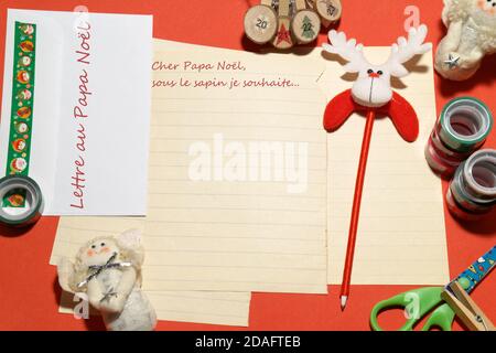 Santa Claus, in French language Papa Noel hanging on branch with ...
