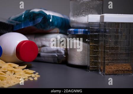 A pile of food supplies on a grey table. Food donation concept. Context ...