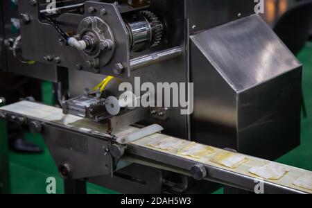 Process of dough sheet pressing machine in food industry Stock Photo ...
