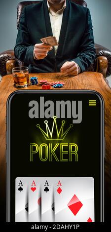 Man with tablet computer playing poker online Stock Photo - Alamy