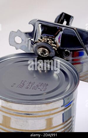 Hand and Tin opener opening a can of food isolated on white Stock Photo ...