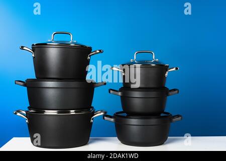 Set of black cookware against blue background Stock Photo - Alamy