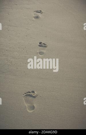 close up of foot imprints on a sandy beach Stock Photo - Alamy