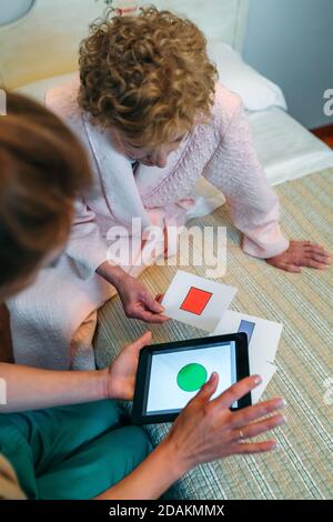 Female doctor showing geometric shapes to elderly patient Stock Photo ...
