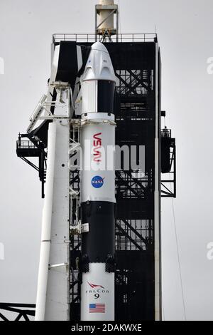 The Crew Dragon spacecraft sits on top of a SpaceX Falcon 9 rocket as ...