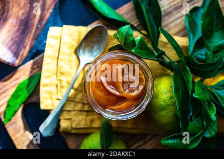 Freshmade tangerine fruit preserve on rustic background with copy space ...