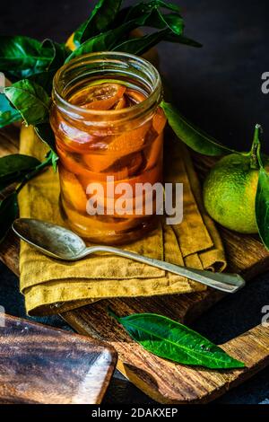 Freshmade tangerine fruit preserve on rustic background with copy space ...