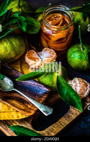 Freshmade tangerine fruit preserve on rustic background with copy space ...