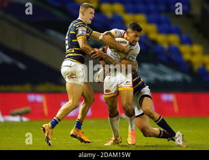 Leeds Rhinos' Ash Handley is tackled by Salford Red Devils' Josh ...