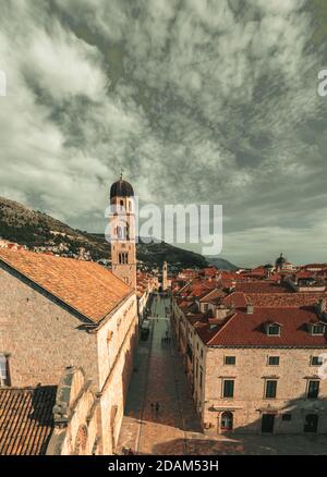 View of the narrow long street surrounded by buildings Stock Photo - Alamy