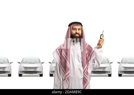 Saudi arab man holding car keys and smiling isolated on white ...