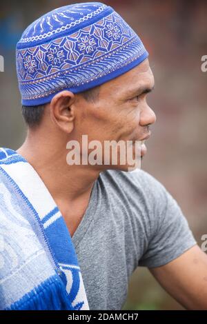 Indonesian man with distinctive songkok type hat. The songkok or peci ...