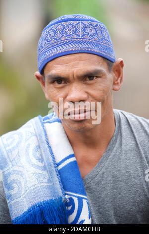 Indonesian man with distinctive songkok type hat. The songkok or peci ...