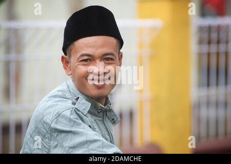 Indonesian man with distinctive songkok type hat. The songkok or peci ...