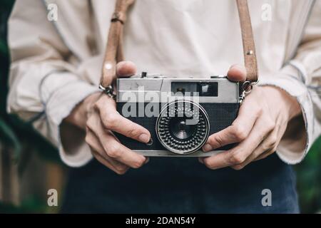 Hipster girl using vintage photo camera close up, copy space, toned ...