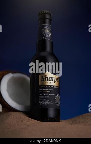 Sharps brewery coconut stout bottle beer on sand with a cocount Stock ...